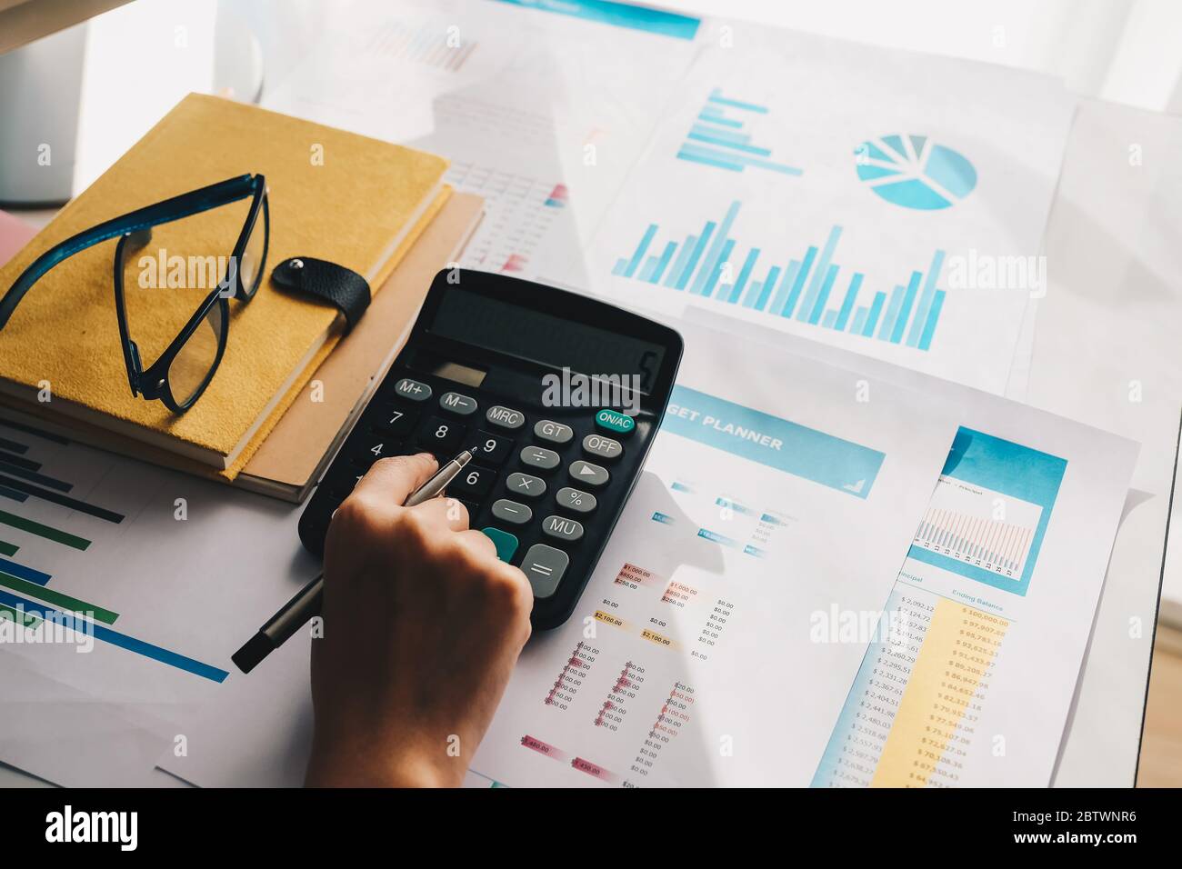 Close up Accountant using calculator for calculating financial expense ...