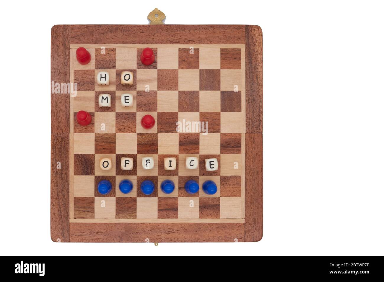 Red game pieces on a small chess board make home office and stay at a ...