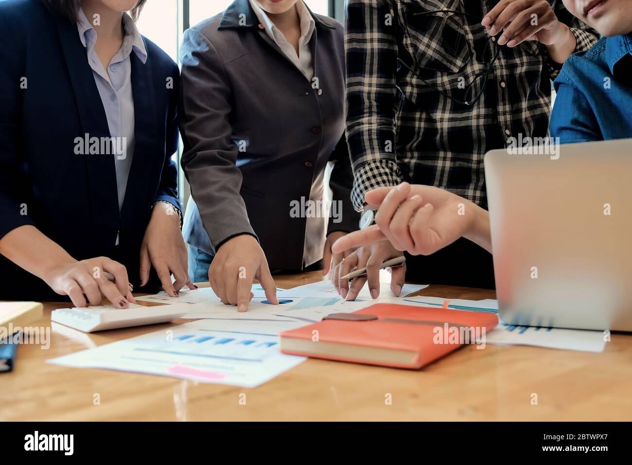 Financial, accounting, investment advisor consulting with her team at ...