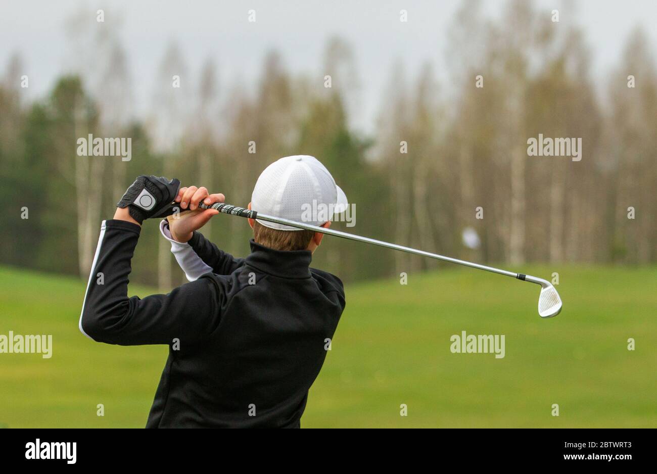 Player a during golf game during a hit Stock Photo - Alamy