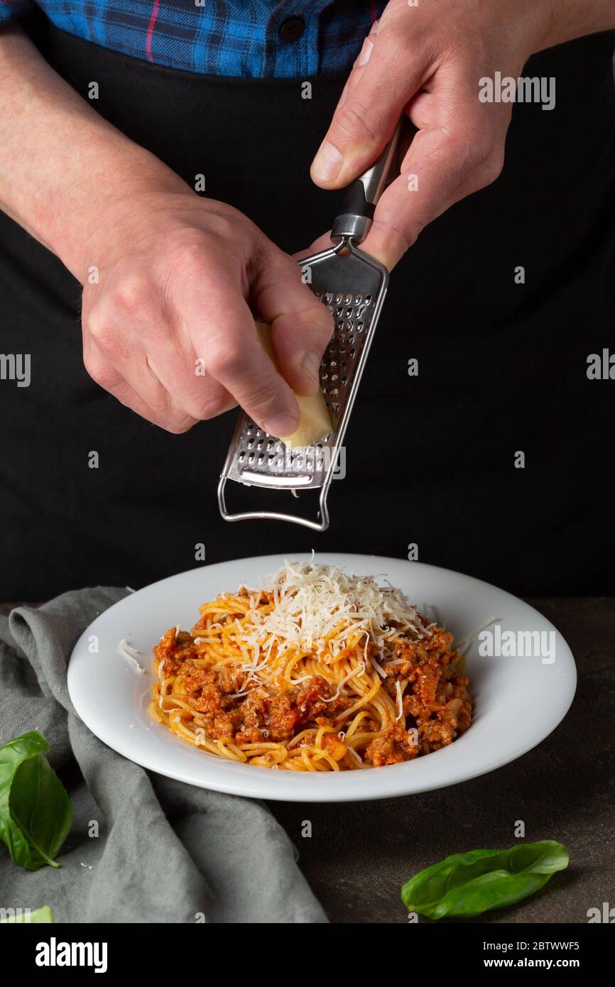 Grating cheese into sauce hi-res stock photography and images - Alamy