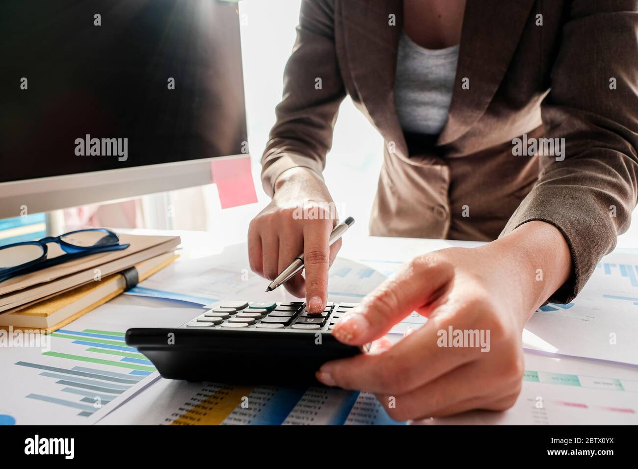 Businessman Accounting Counting with calculator and financial Stock ...