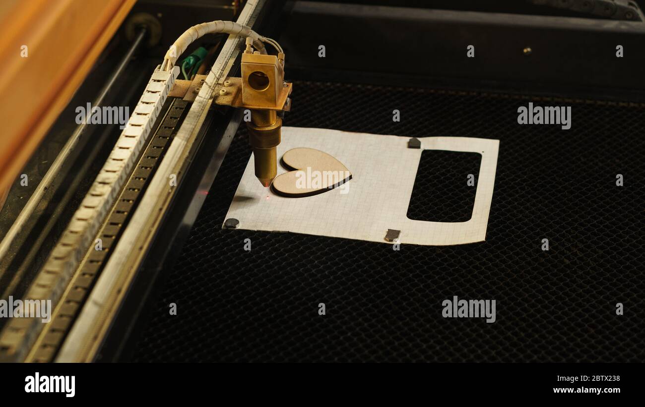 Laser cutting beam high precision on a plywood sheet. Modern technology ...