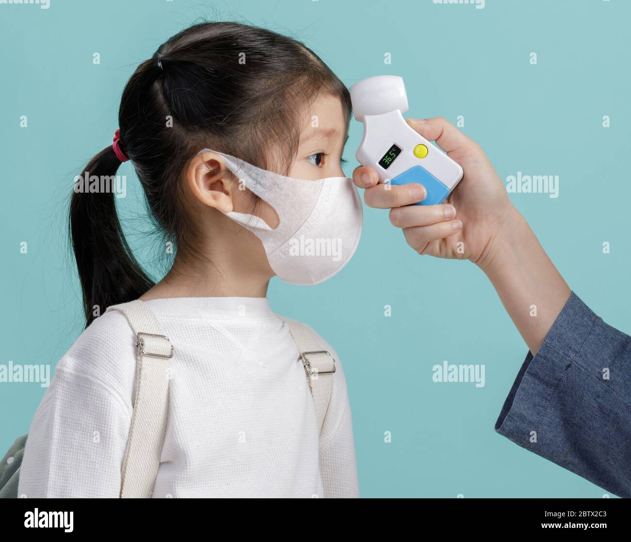 Mom and Asian little child girl wearing respirator mask to protect ...