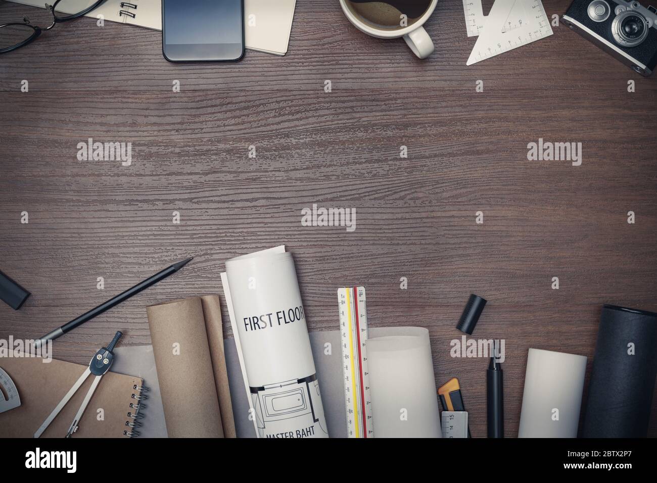 Creative flat lay of architects wooden table with roll blueprints ...
