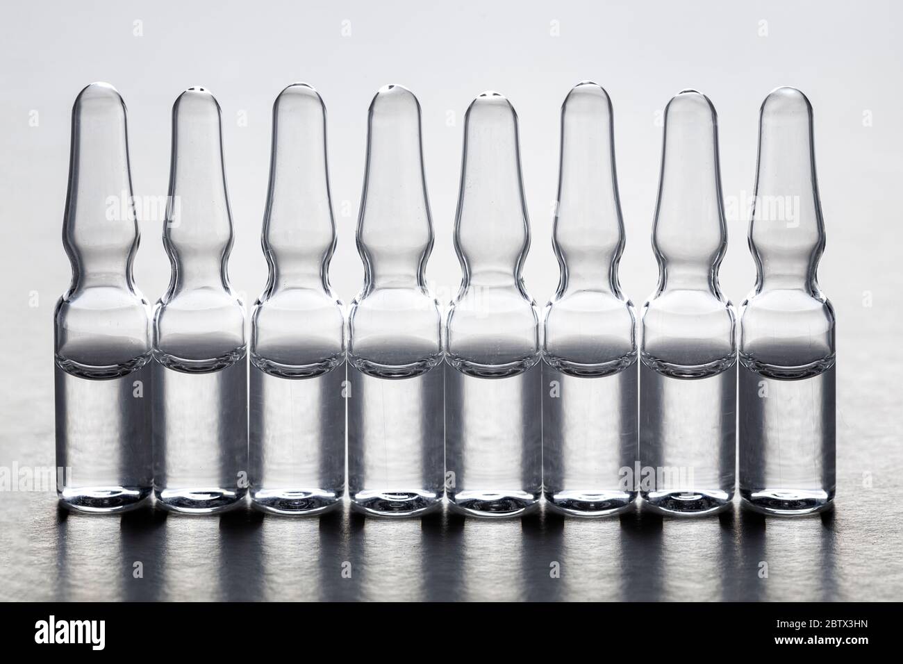 Medical glass ampules on white background with reflection Stock Photo ...