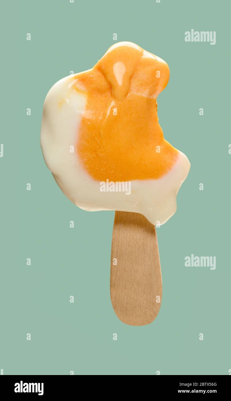 mostly eaten egg shape popsicle on green background Stock Photo - Alamy