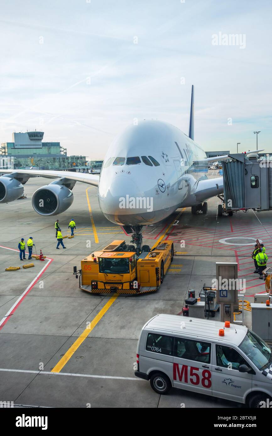 Aircraft push-back with a tug on a airport Stock Photo - Alamy
