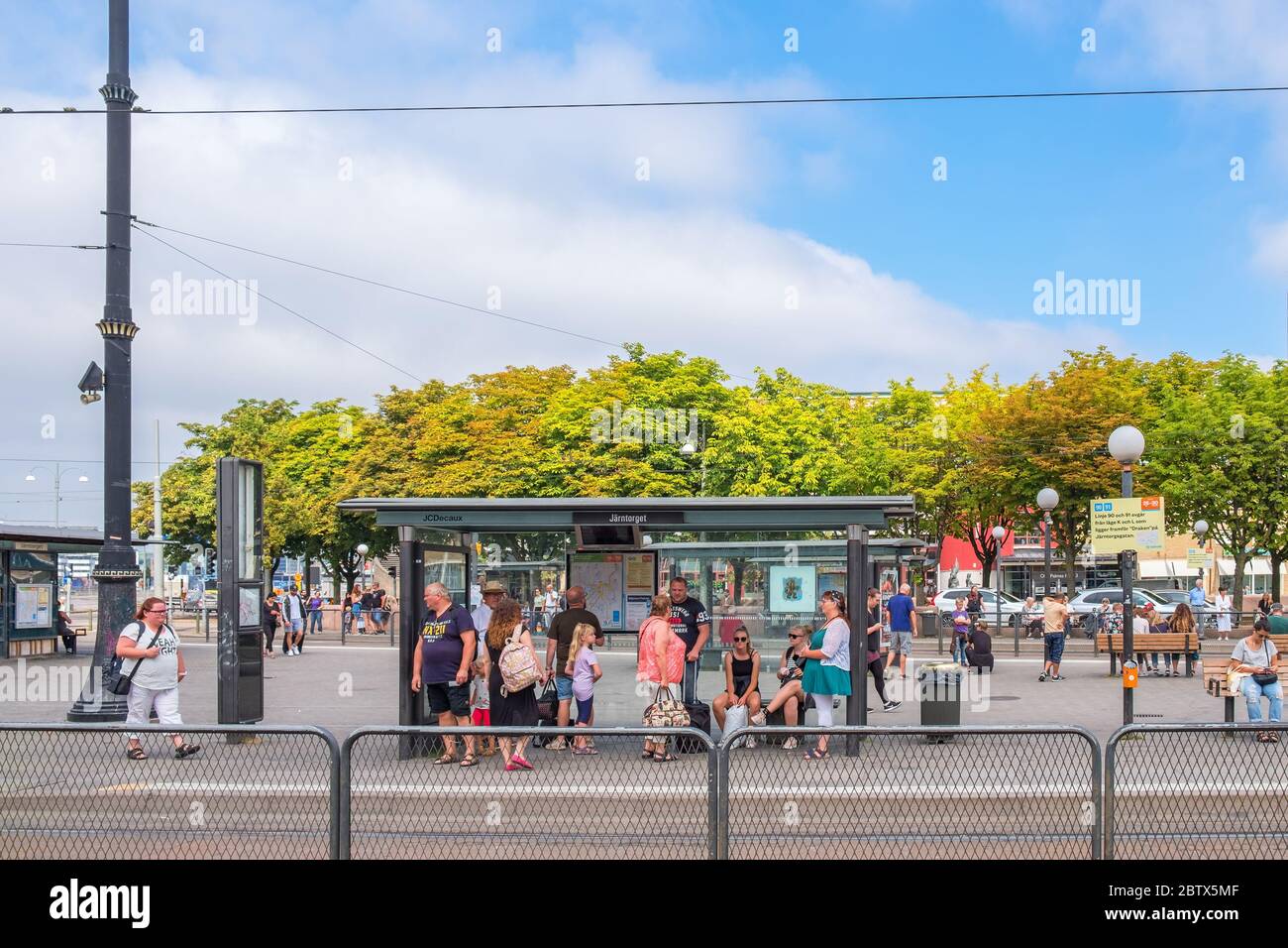 Family waiting at bus stop hi-res stock photography and images - Alamy