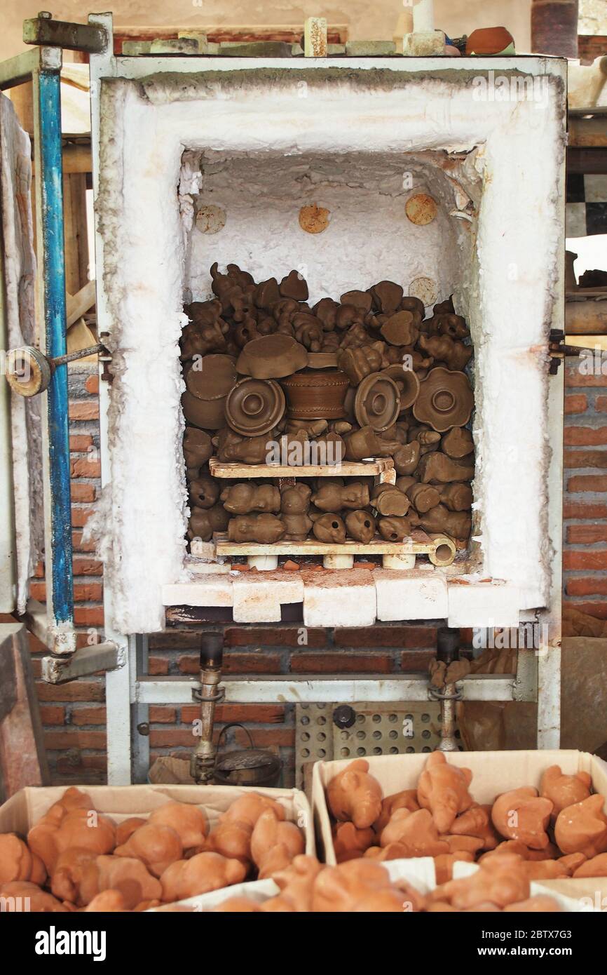 Pottery craft neatly arranged in a oven that is ready to do the ...
