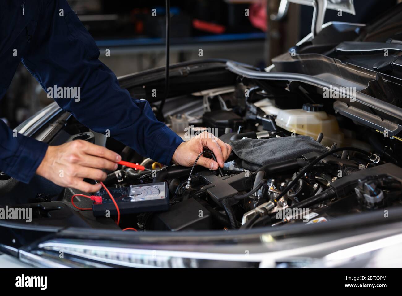mechanics hand check electrical wiring vehicle system in a car service Stock Photo Alamy