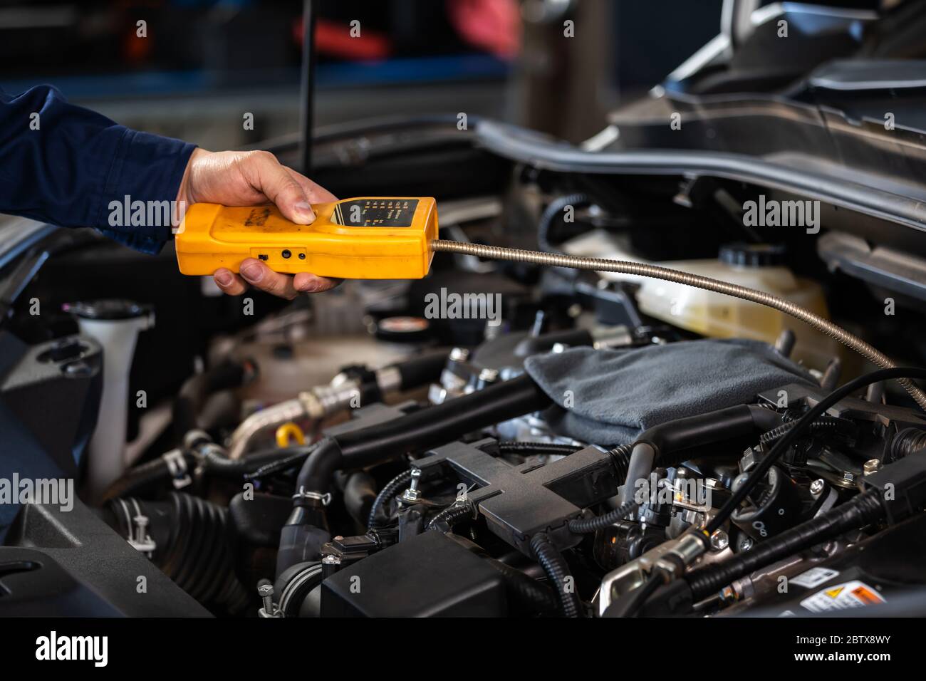 mechanic hand check for leaks in GAS LPG gasoline in a car Stock Photo ...