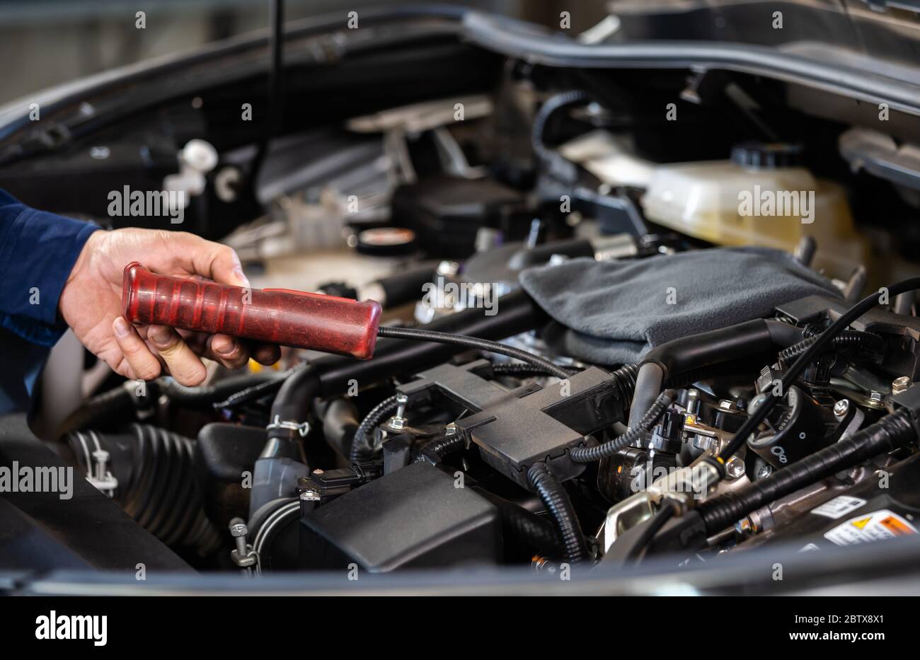 mechanic hand using Tachometer checking engine of a car Stock Photo - Alamy