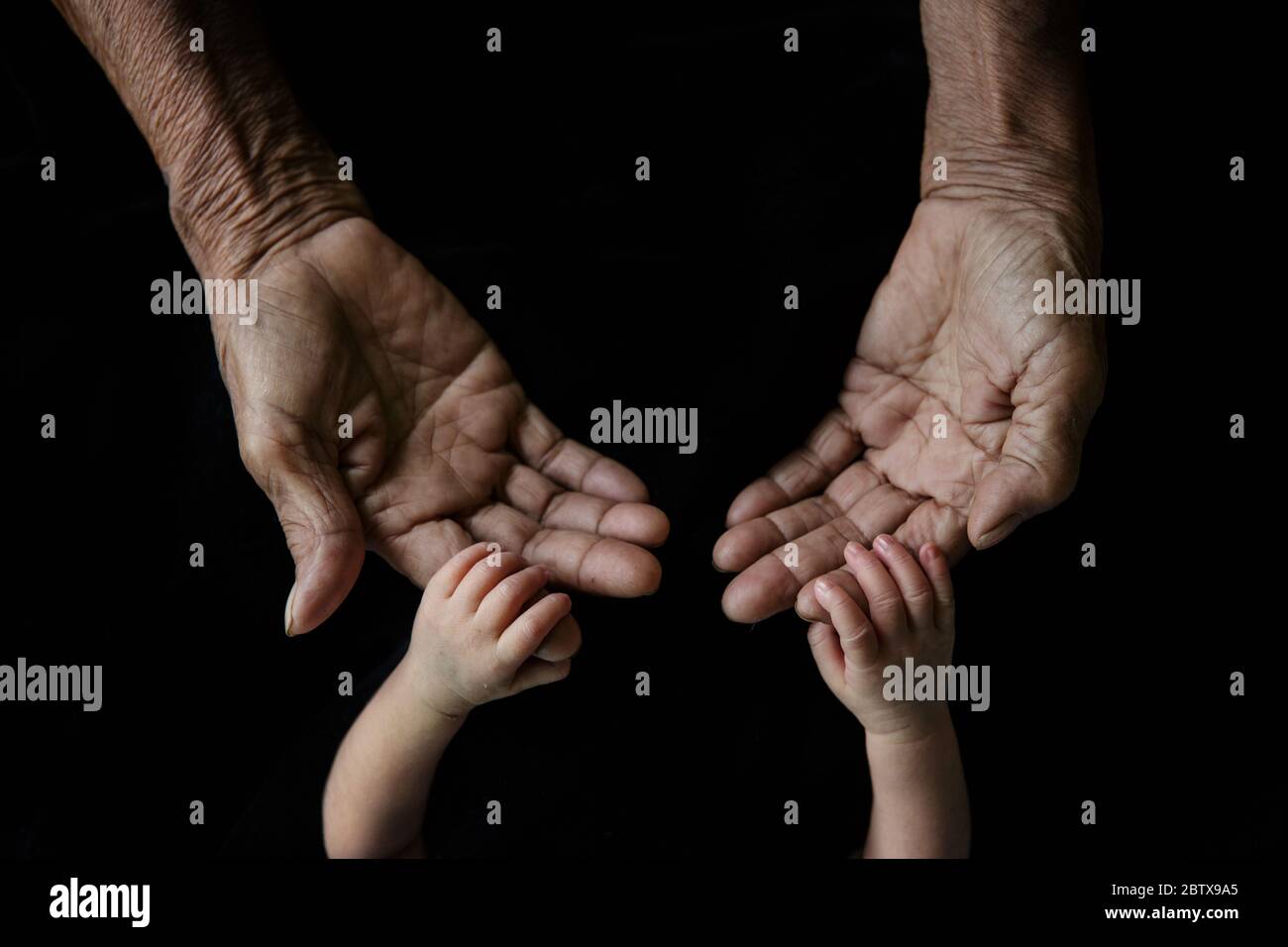 Old baby hands touching hi-res stock photography and images - Alamy