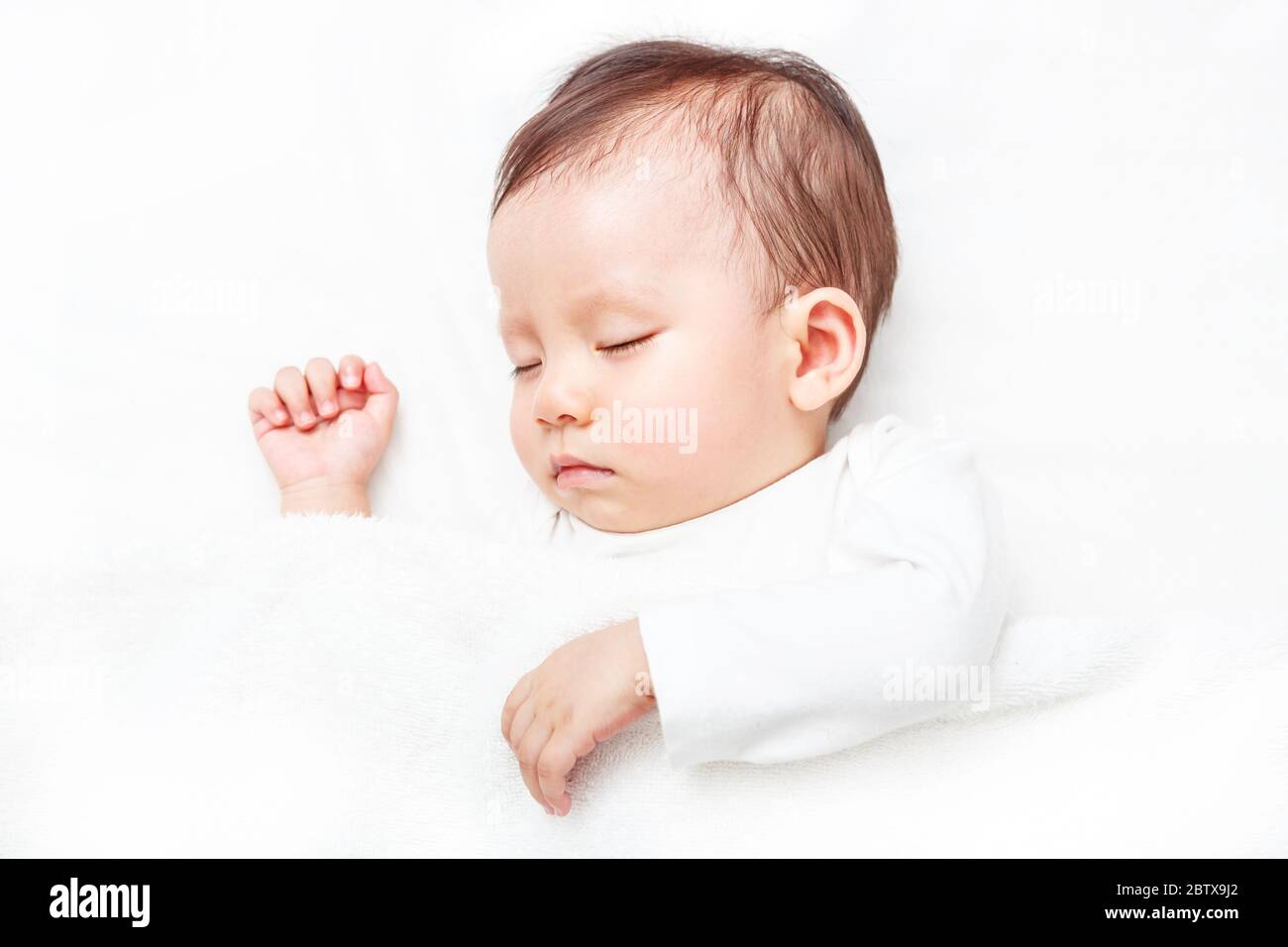 Newborn sleeping on the white bed (isolated on white background Stock ...