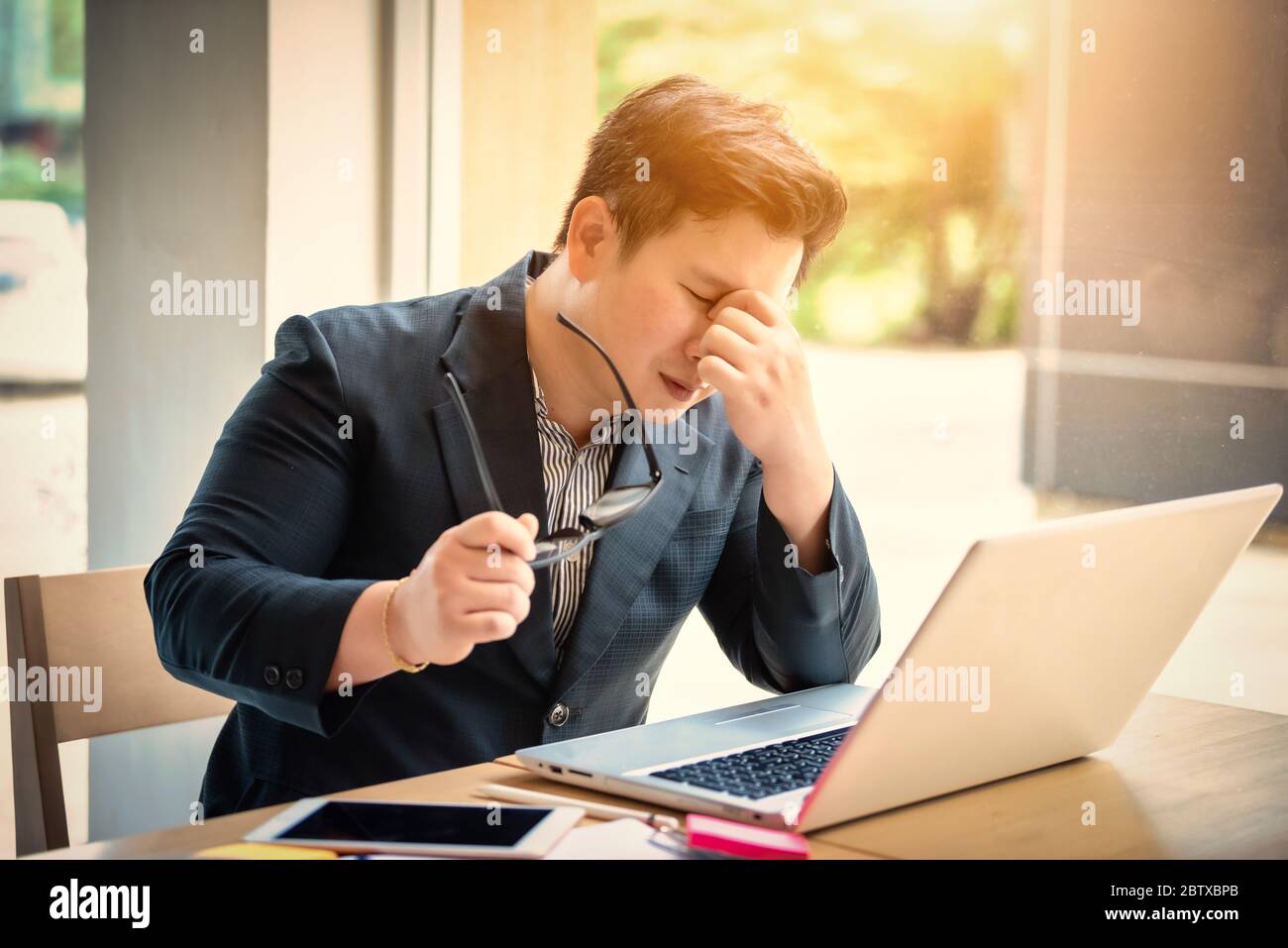 Sad businessman stressed and worried sitting in office. Stress and ...