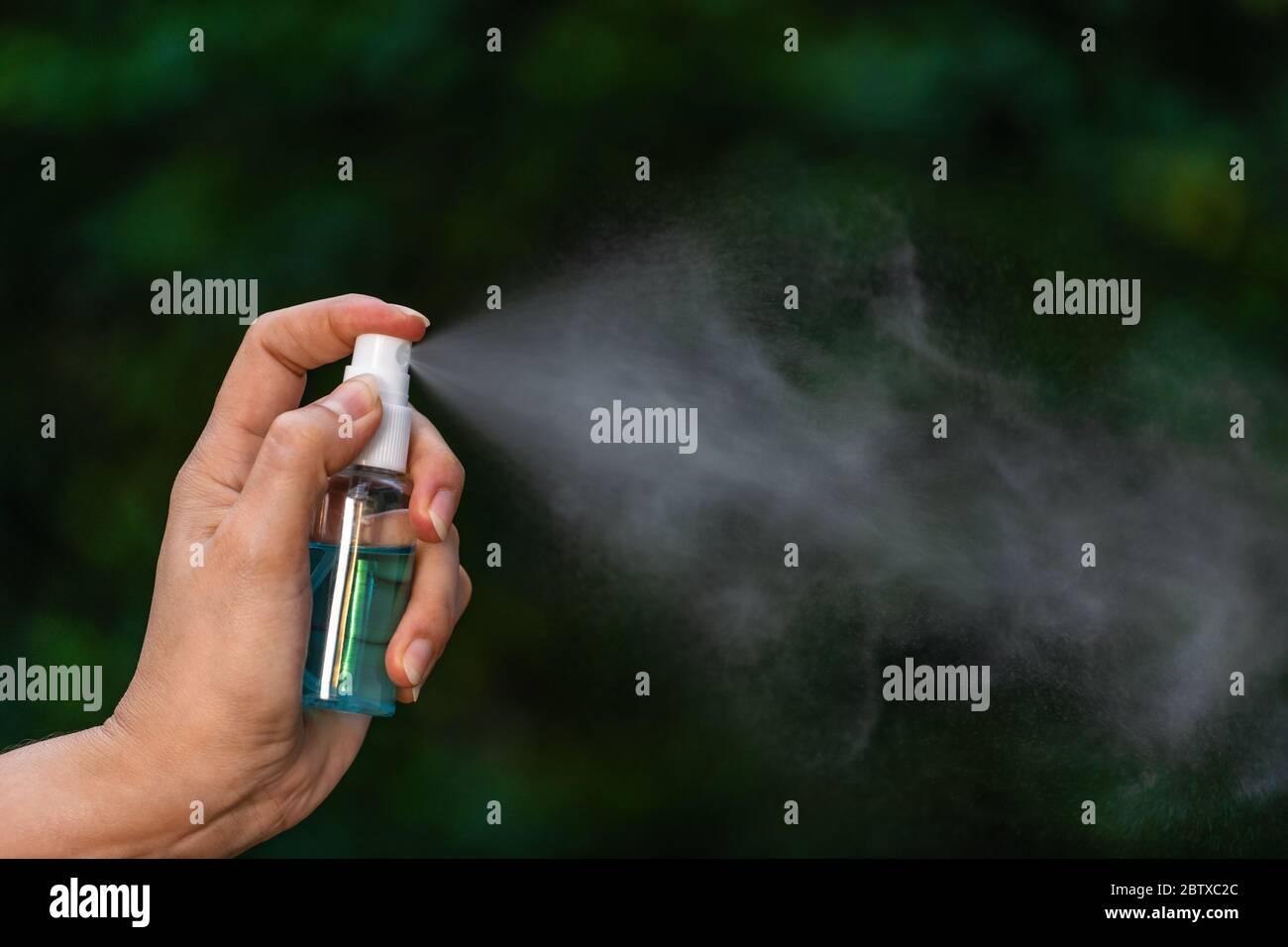 hand using alcohol spray for protect from infection of virus and germ ...