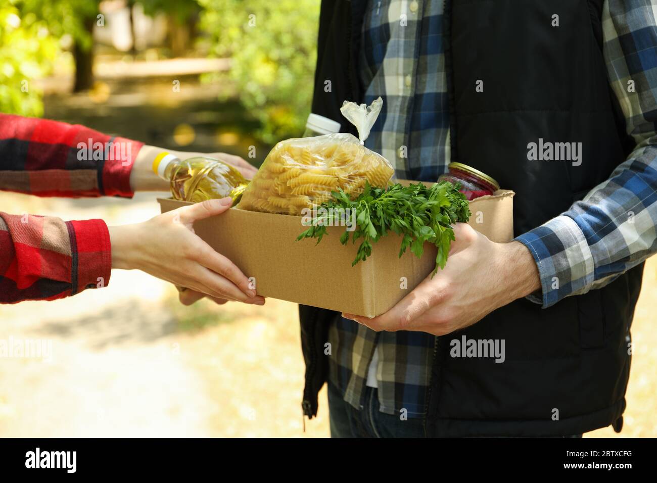 Woman volunteer hold box hi-res stock photography and images - Alamy