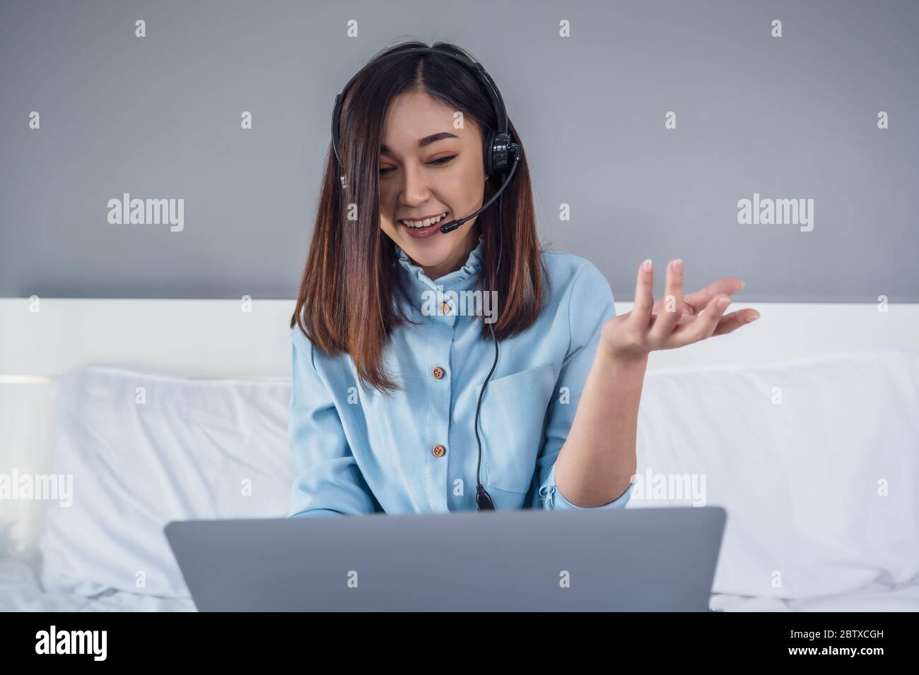 business woman wear headset video conference calling on laptop computer ...