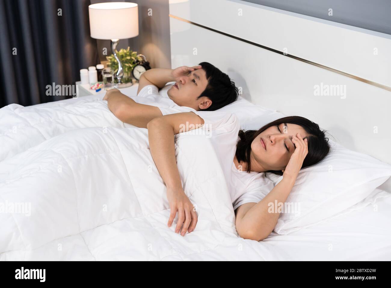 sick couple headache and suffering from virus disease and fever on bed ...