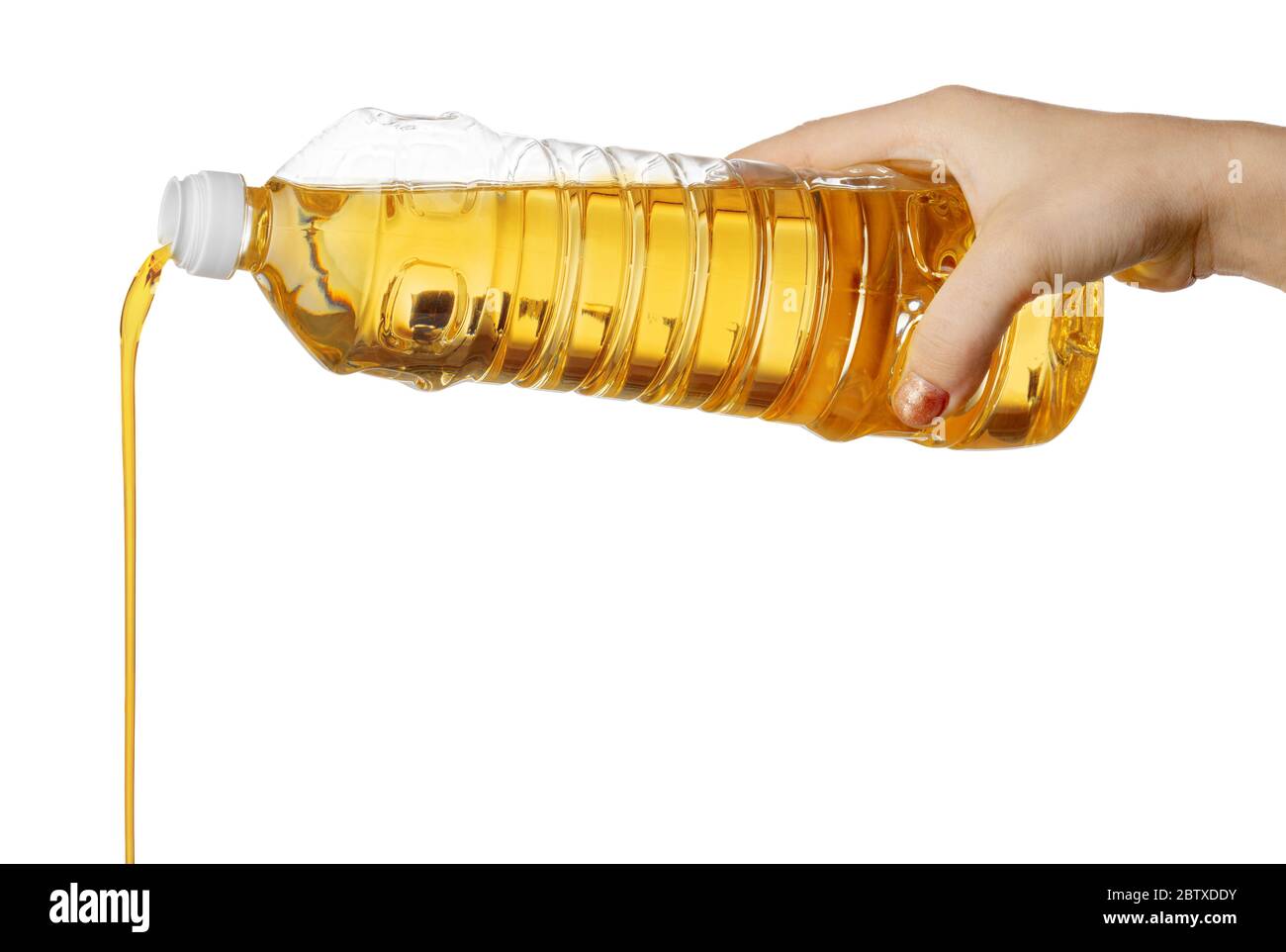 Hand of woman pouring cooking oil from plastic bottle. Isolated on ...