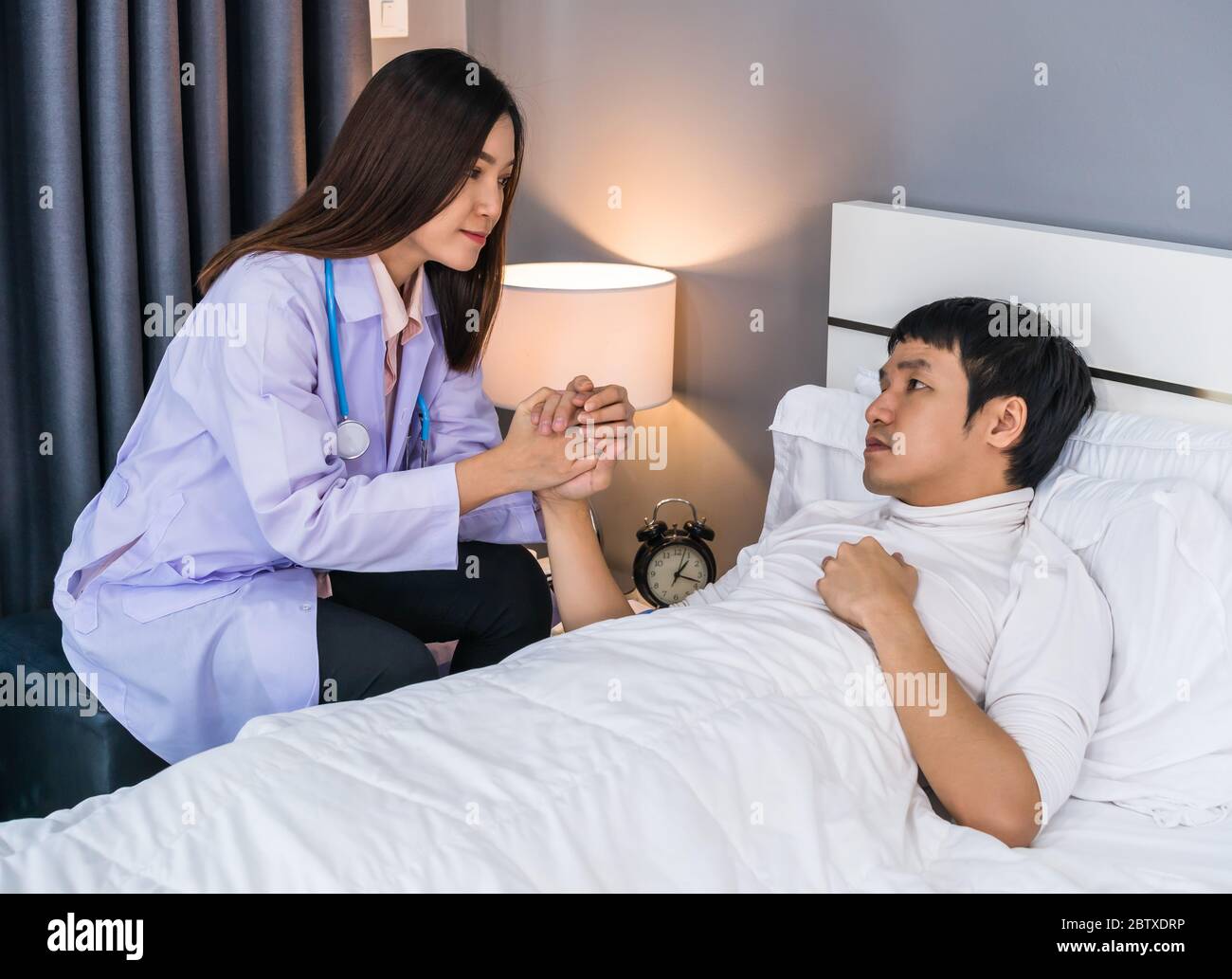 doctor talking and advising with sick man on a bed Stock Photo - Alamy