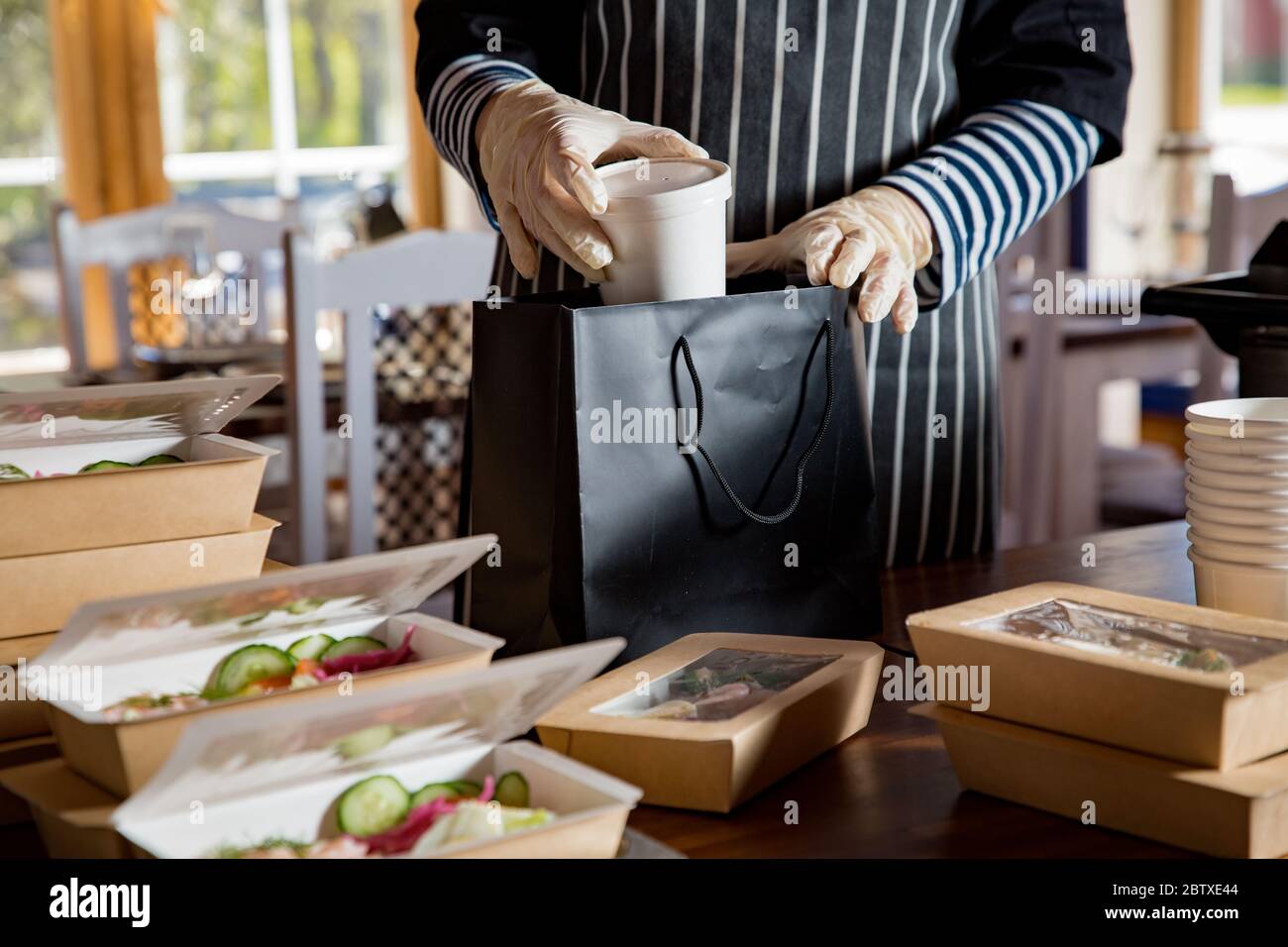 Chef wearing protective gloves hi-res stock photography and images - Alamy