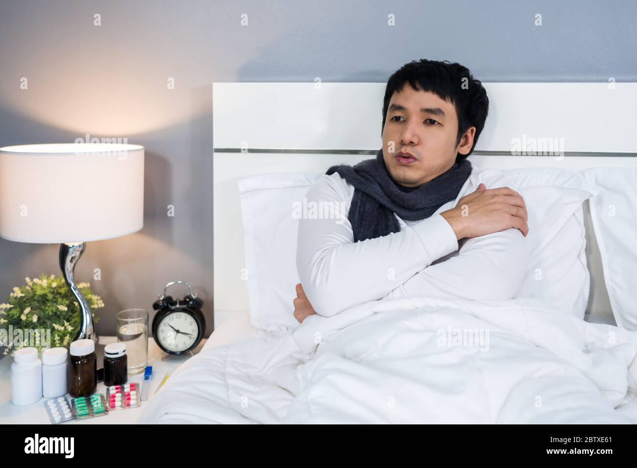 sick man feeling cold in a bed Stock Photo - Alamy