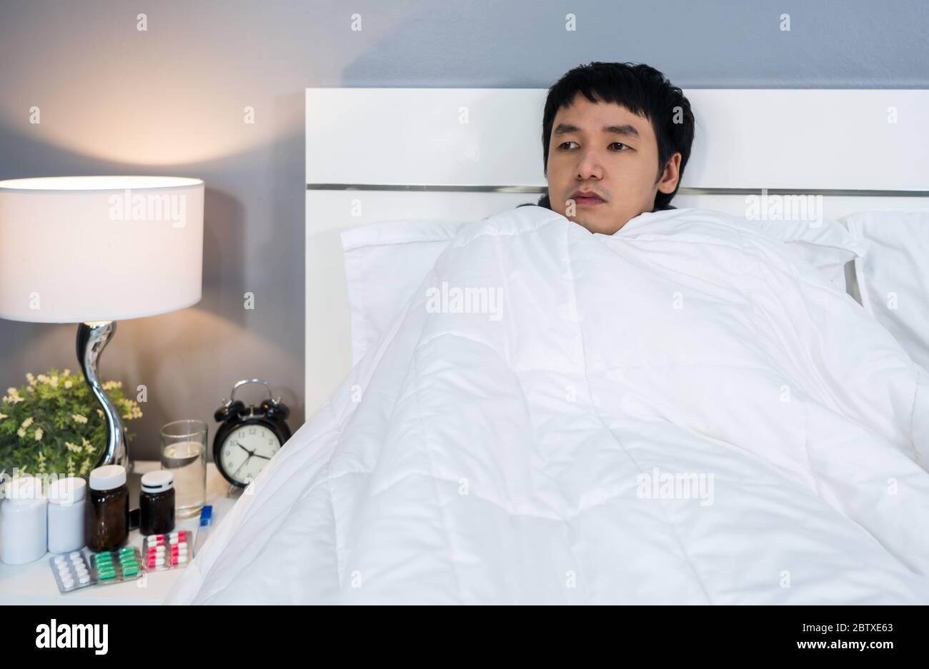 sick man feeling cold in a blanket on bed at home Stock Photo - Alamy