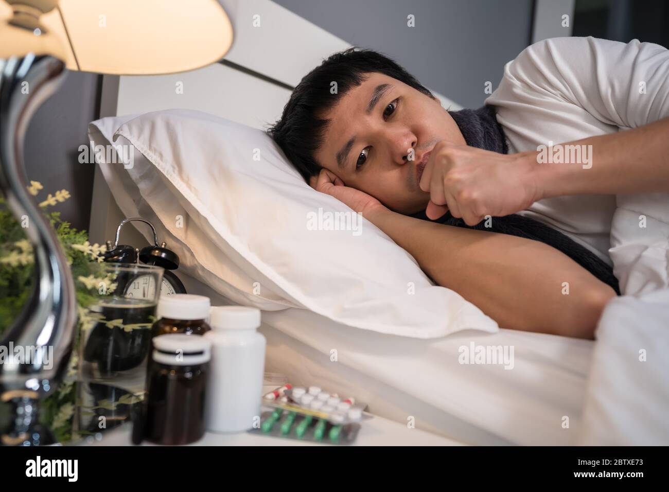 Coughing man in bed morning hi-res stock photography and images - Alamy