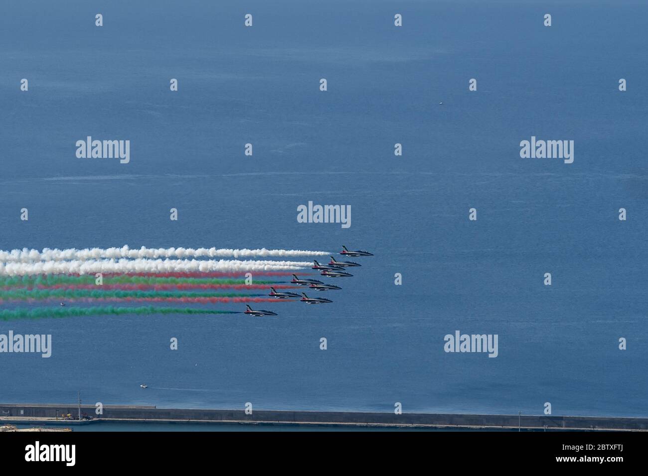 tricolor arrows cross the sky of Genoa leaving their colored trails ...