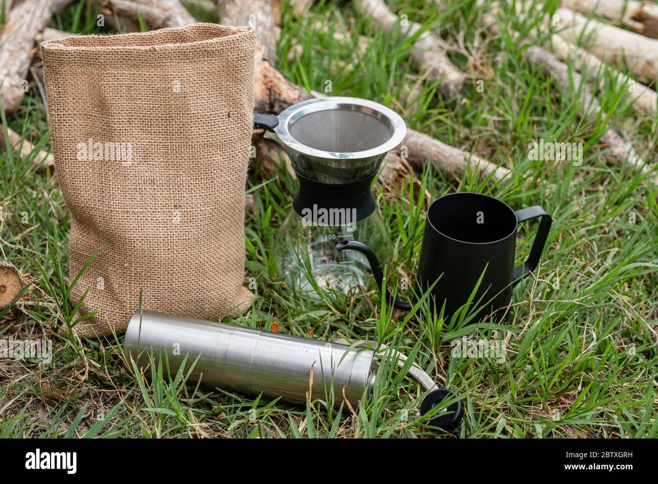Coffee maker on the green grass and tree branches lined Stock Photo - Alamy