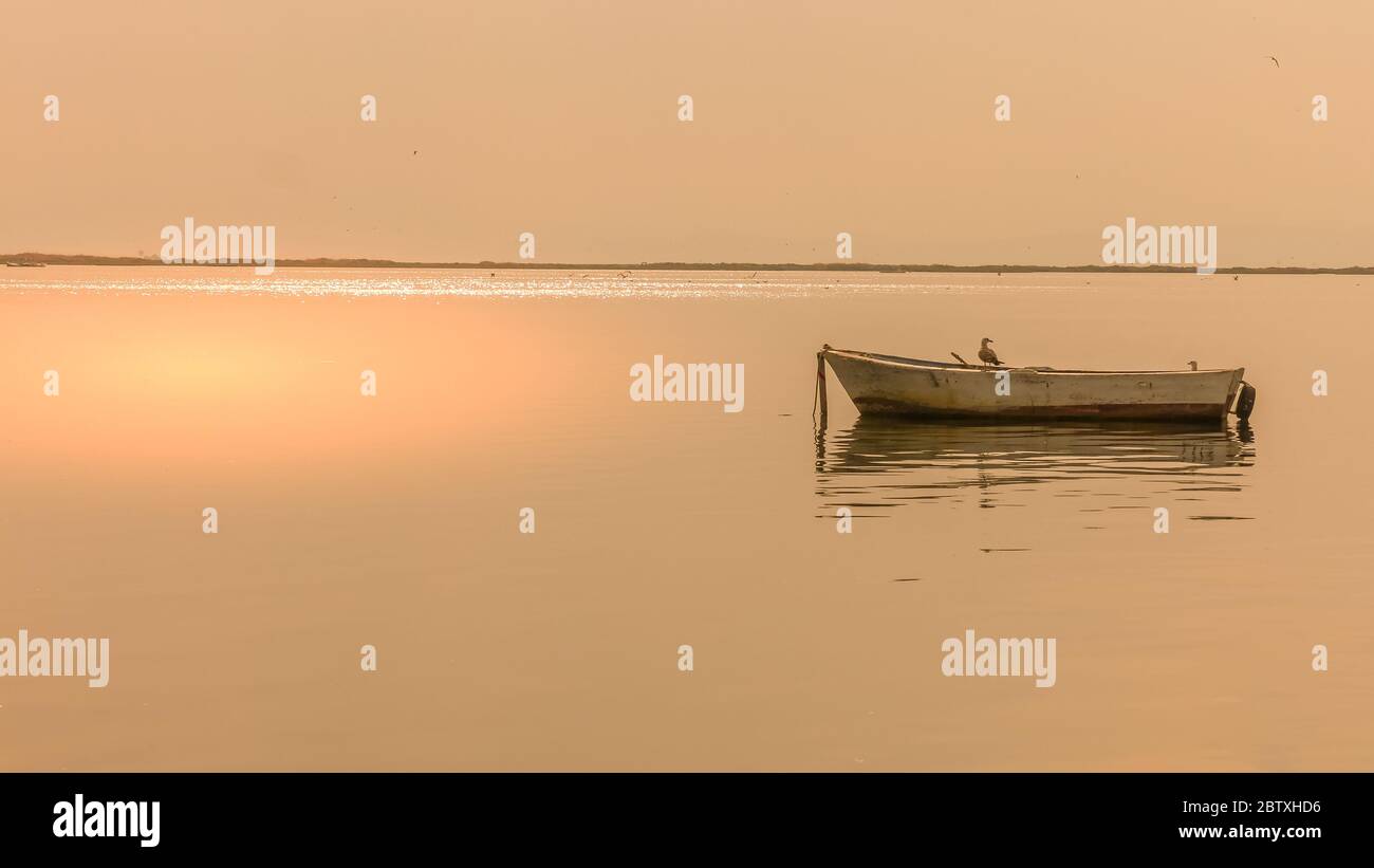 Small fishing boat floating on the sea water Stock Photo - Alamy