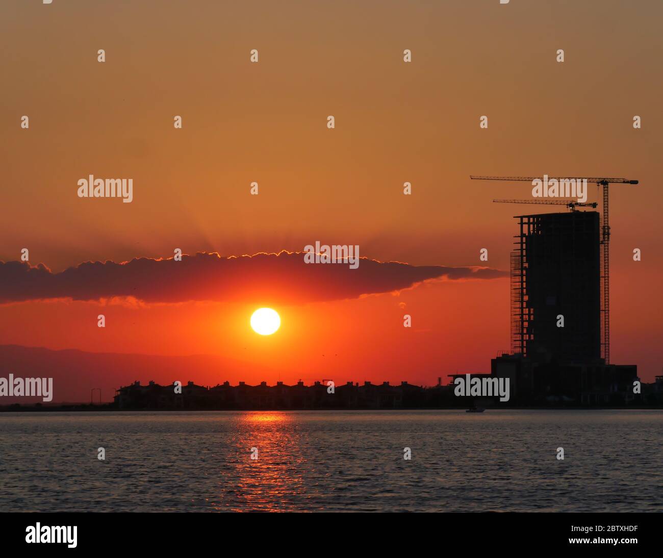 Construction Tower and sky-scraper building and crane against colorful ...