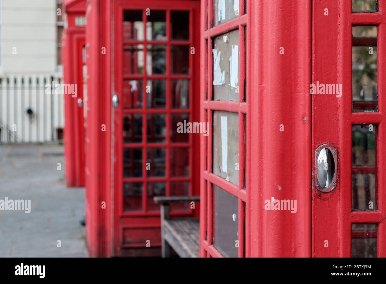 Red phone booth detail - a row of British phone boxes, bright red in ...