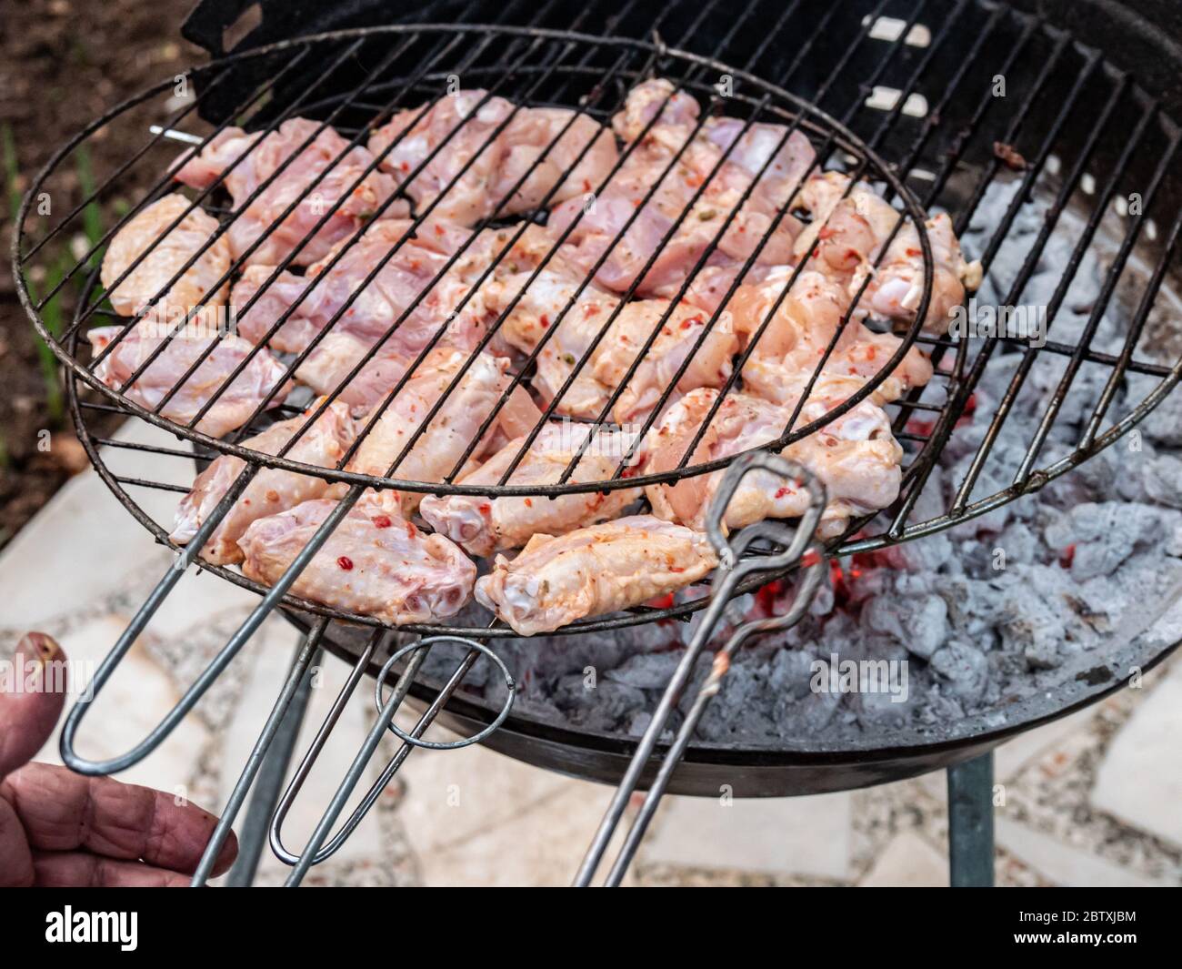 Grilled chicken legs on the flaming barbeque grill. food concept Stock ...