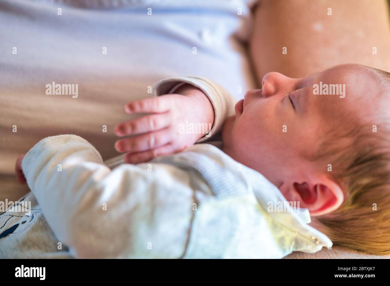 Woman embracing newborn baby outdoor Stock Photo - Alamy