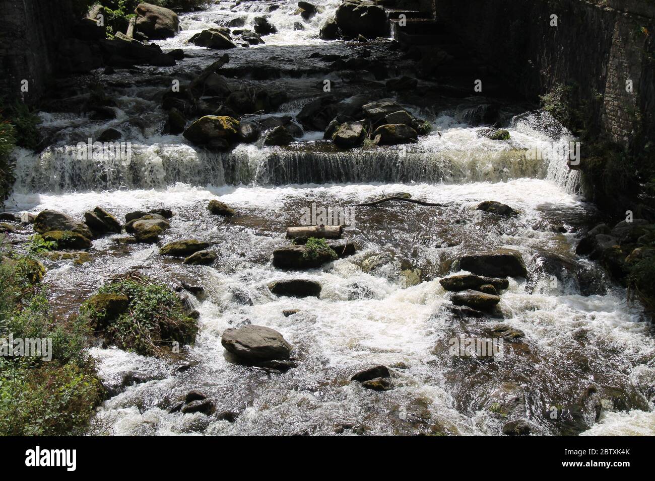 The Rocks and Weir of a Fast Flowing River Stock Photo - Alamy