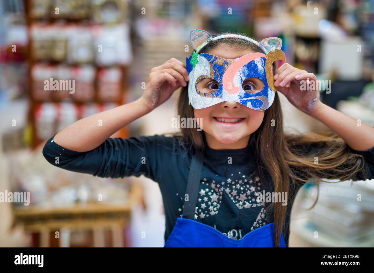 Young girl learning how to create mask. Children lab Stock Photo - Alamy