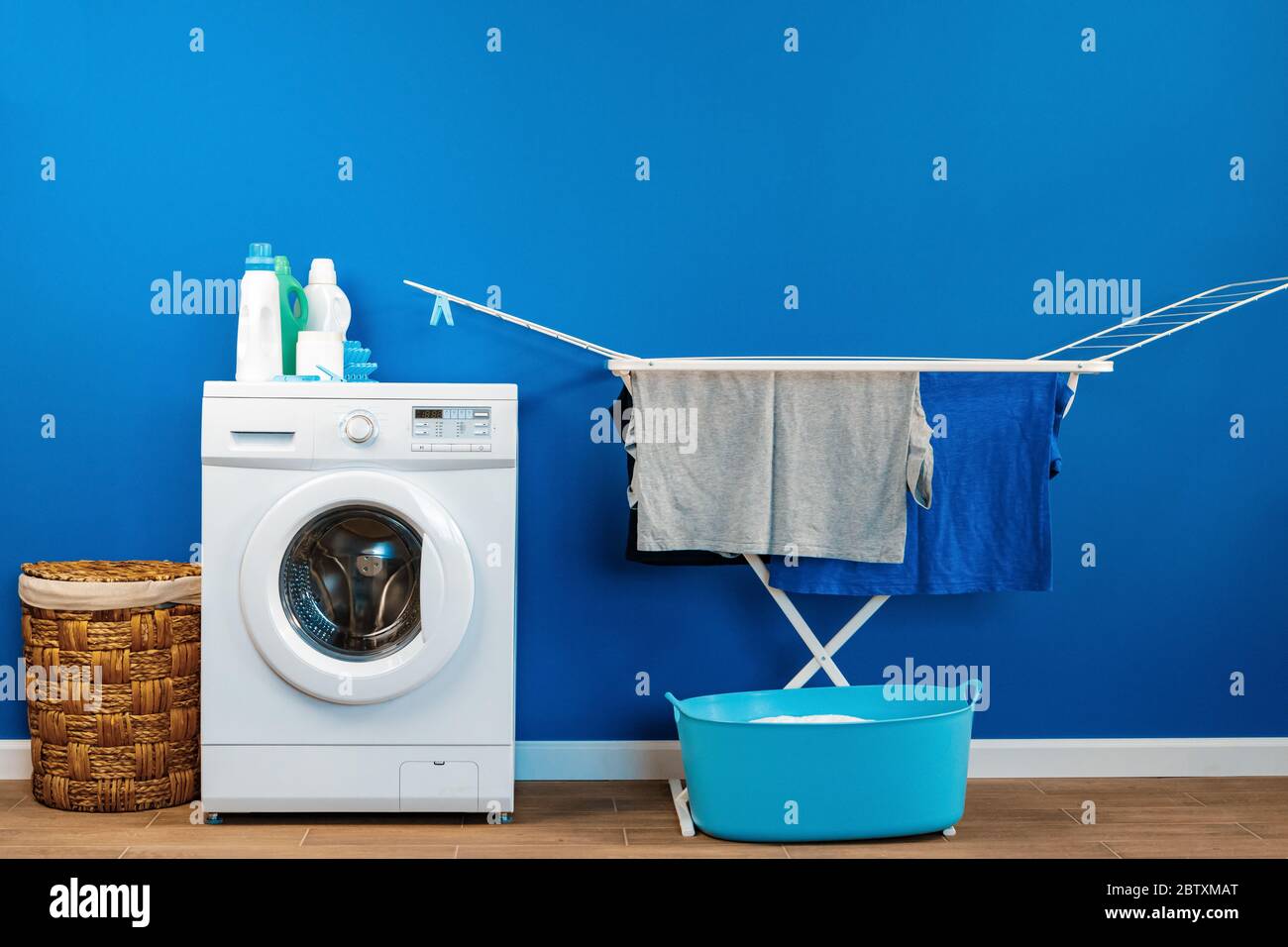 Laundry room interior with washing machine and clothes dryer near wall ...