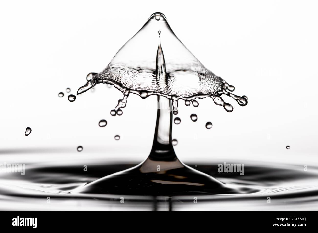 Closeup of collision of two water droplets hitting the surface, white ...