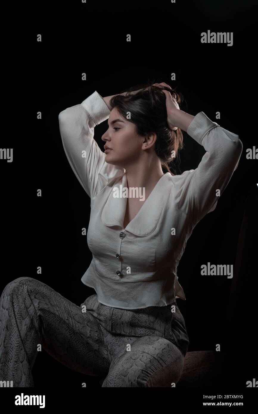 Beautiful model posing over black background, portrait Stock Photo - Alamy