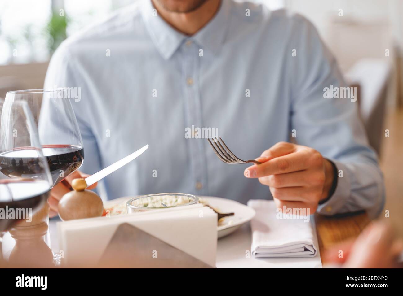 Young man eating delicious food in restaurant Stock Photo - Alamy