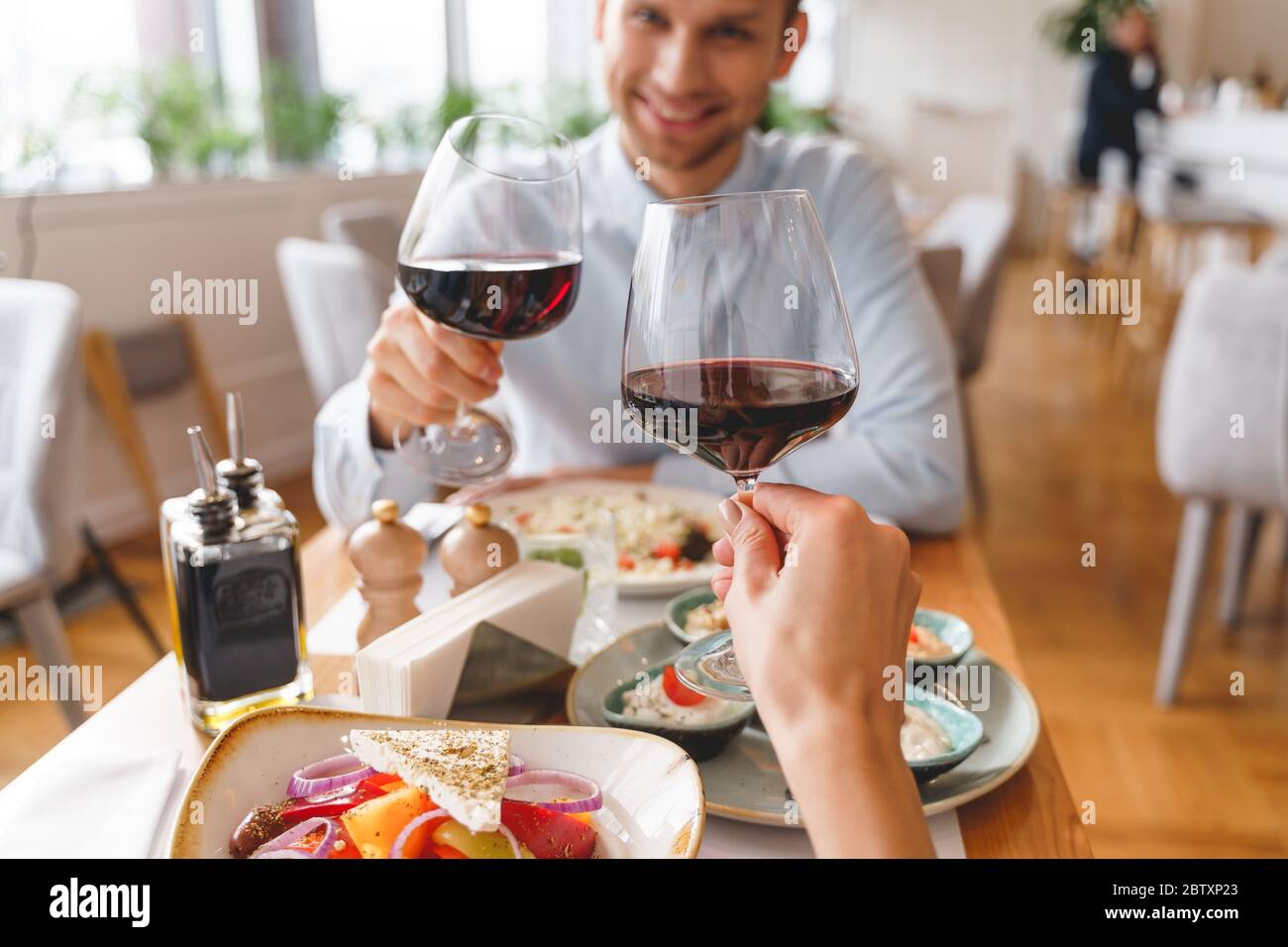 Smiling young man and woman toasting with wine in restaurant Stock ...