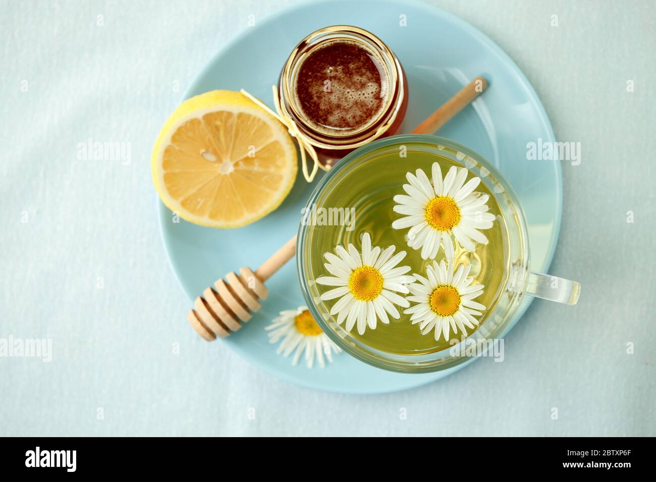 Chamomile flowers and chamomile tea. Chamomile tea in glass teacup with ...