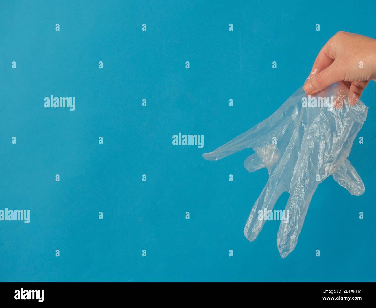 Hand with plastic glove on blue background with copy space Stock Photo ...