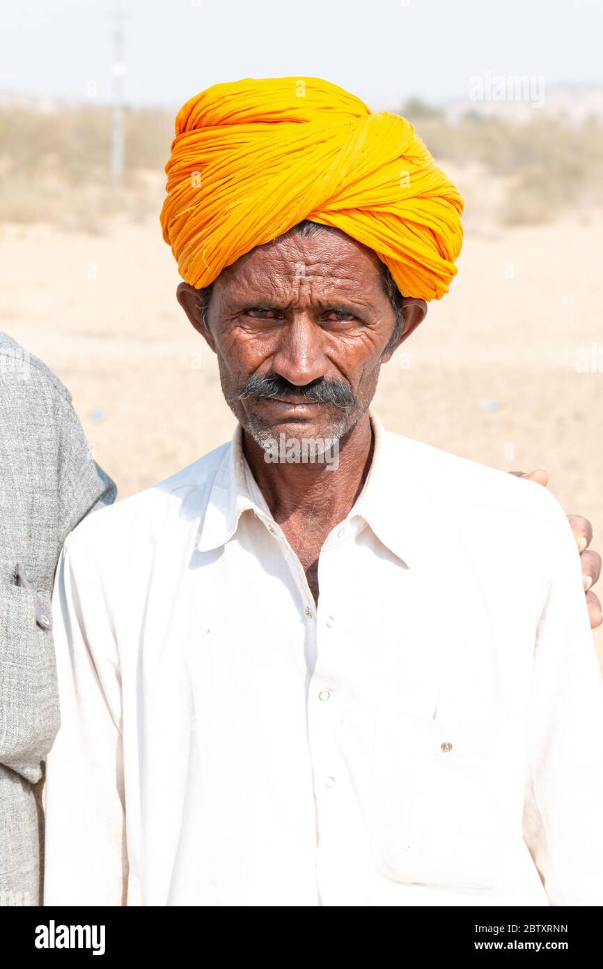 Portrait of a man from Jaisalmer standing in the thar desert with ...