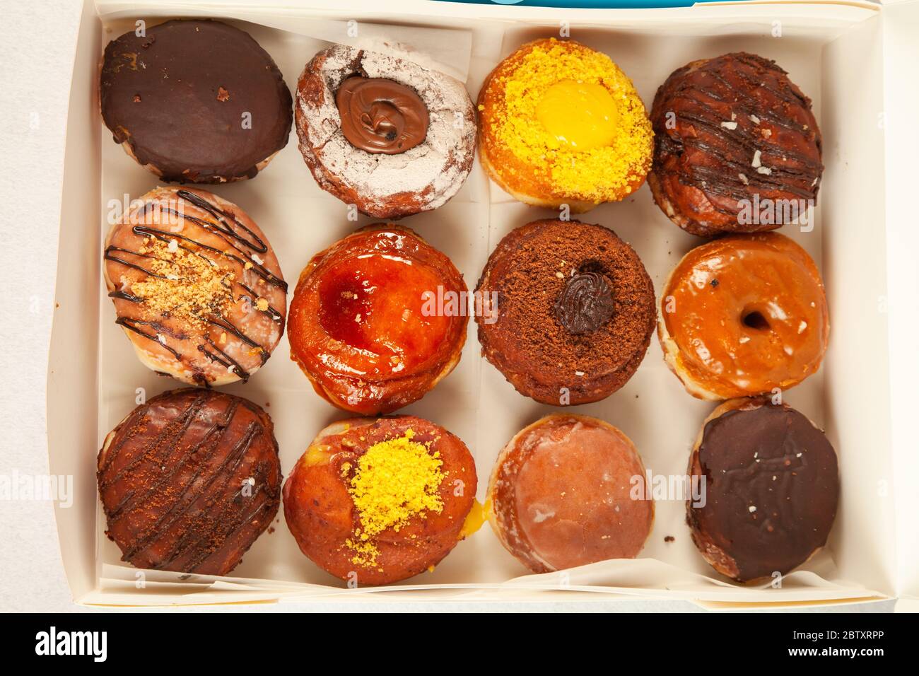 Assorted gourmet doughnuts with filling and delicious toppings freshly ...