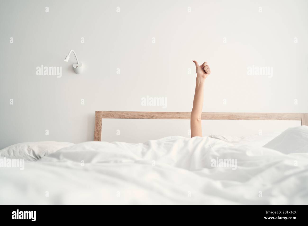 Hand sticking out from under the blanket Stock Photo - Alamy