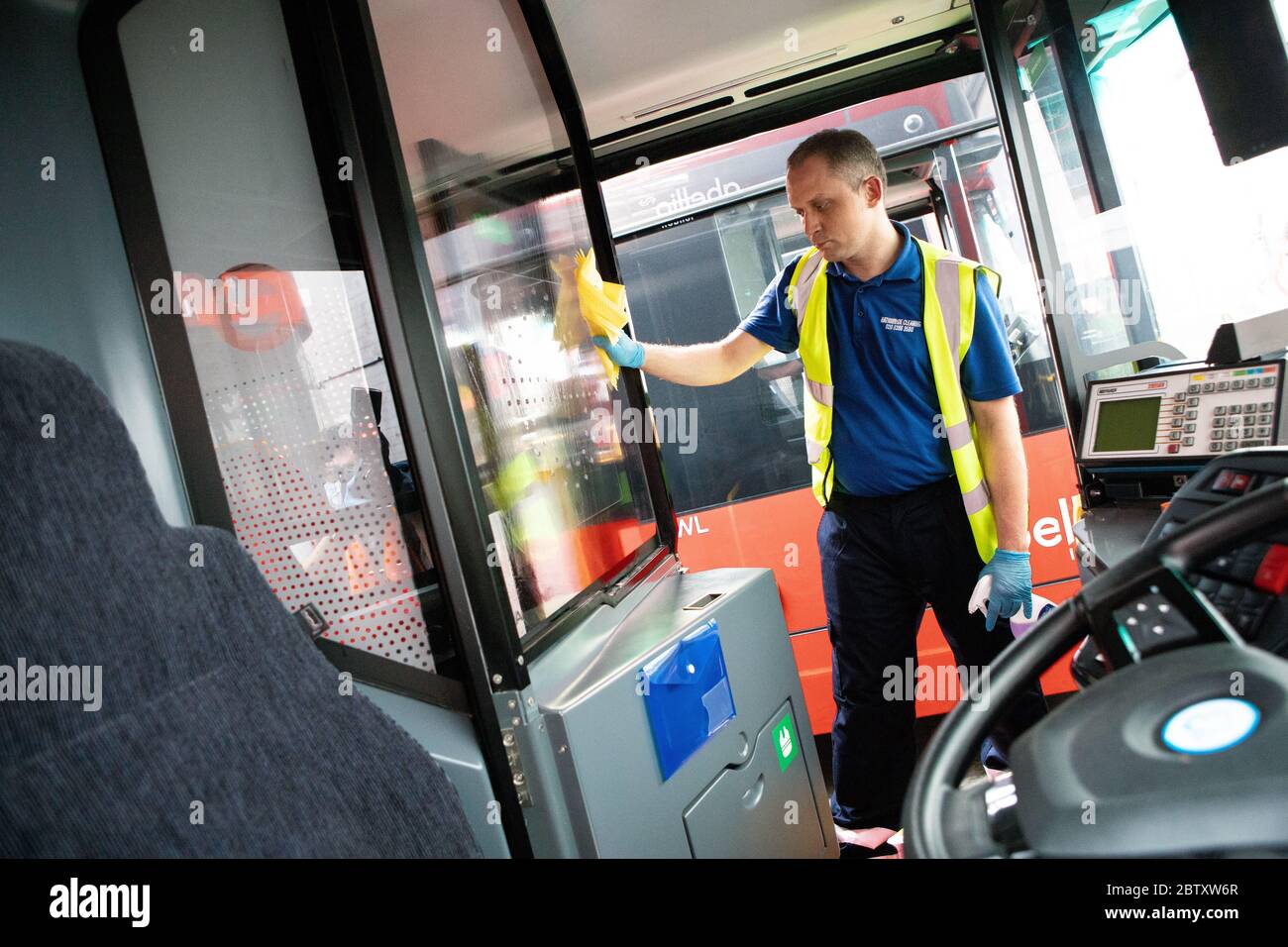 A bus is given a daily cleaning by a cleaner at Camberwell bus garage ...